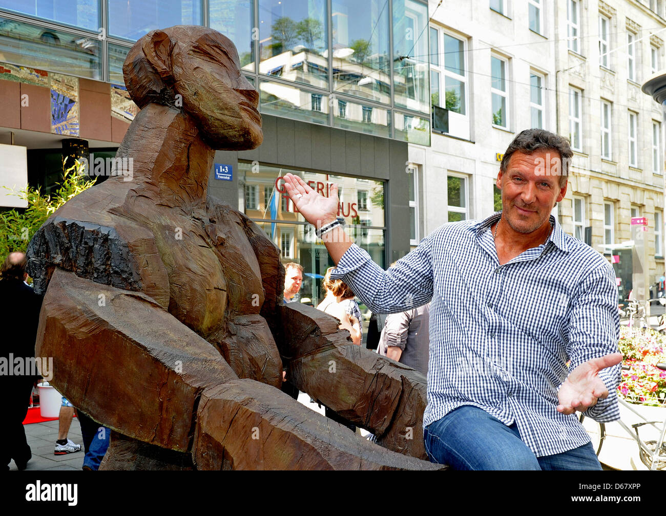 The actor Ralf Moeller sits on a sculptur during the summer festival of ...
