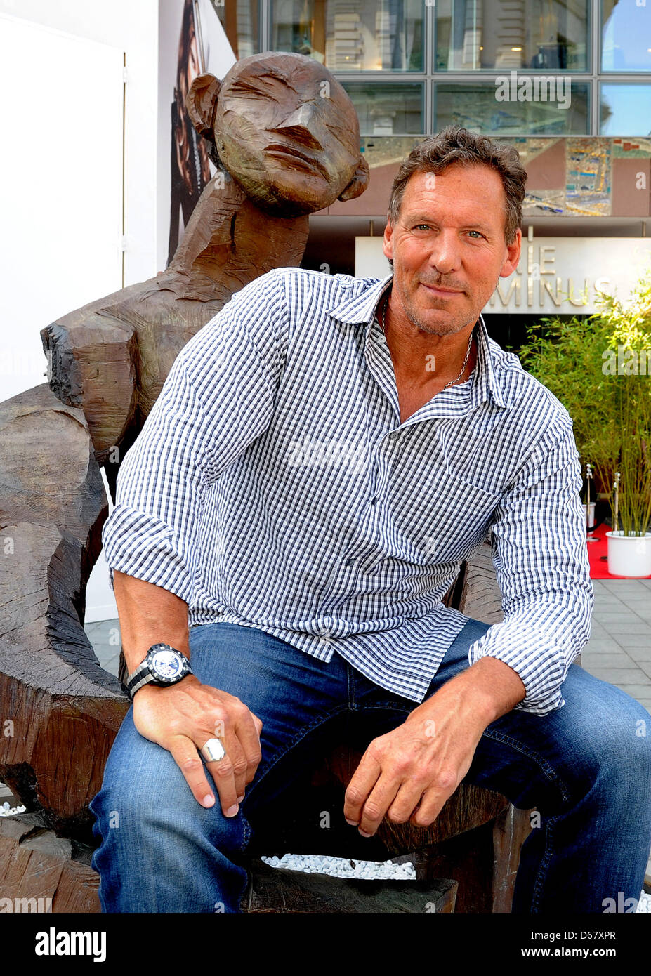 The actor Ralf Moeller sits on a sculptur during the summer festival of ...