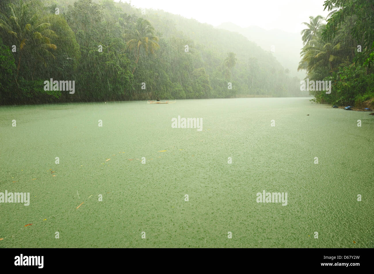 Tropical rain above river Stock Photo - Alamy