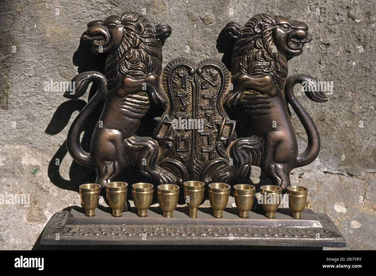 An old decorative bronze menorah lamp, which is a traditional nine ...