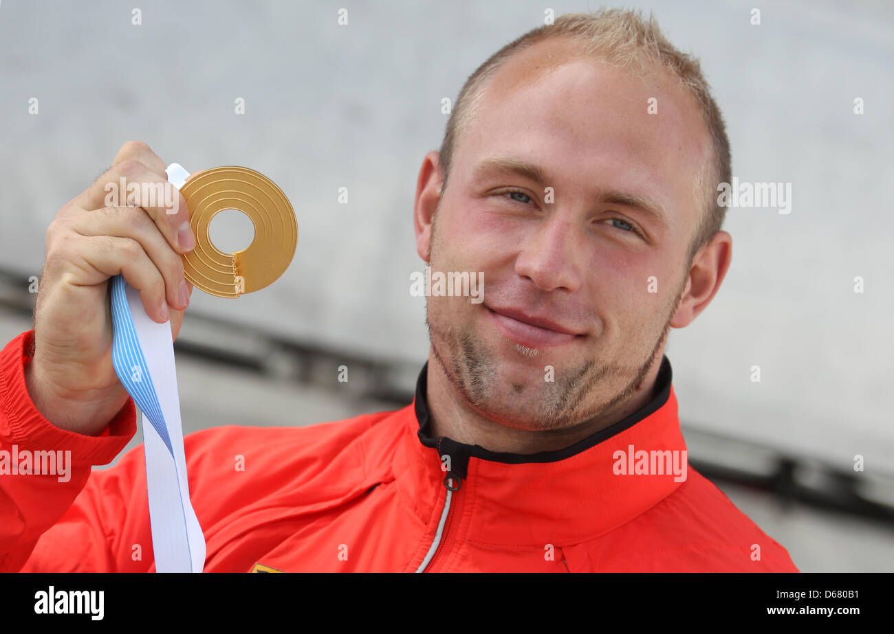 Robert Harting from Germany displays his gold medal after he won the ...