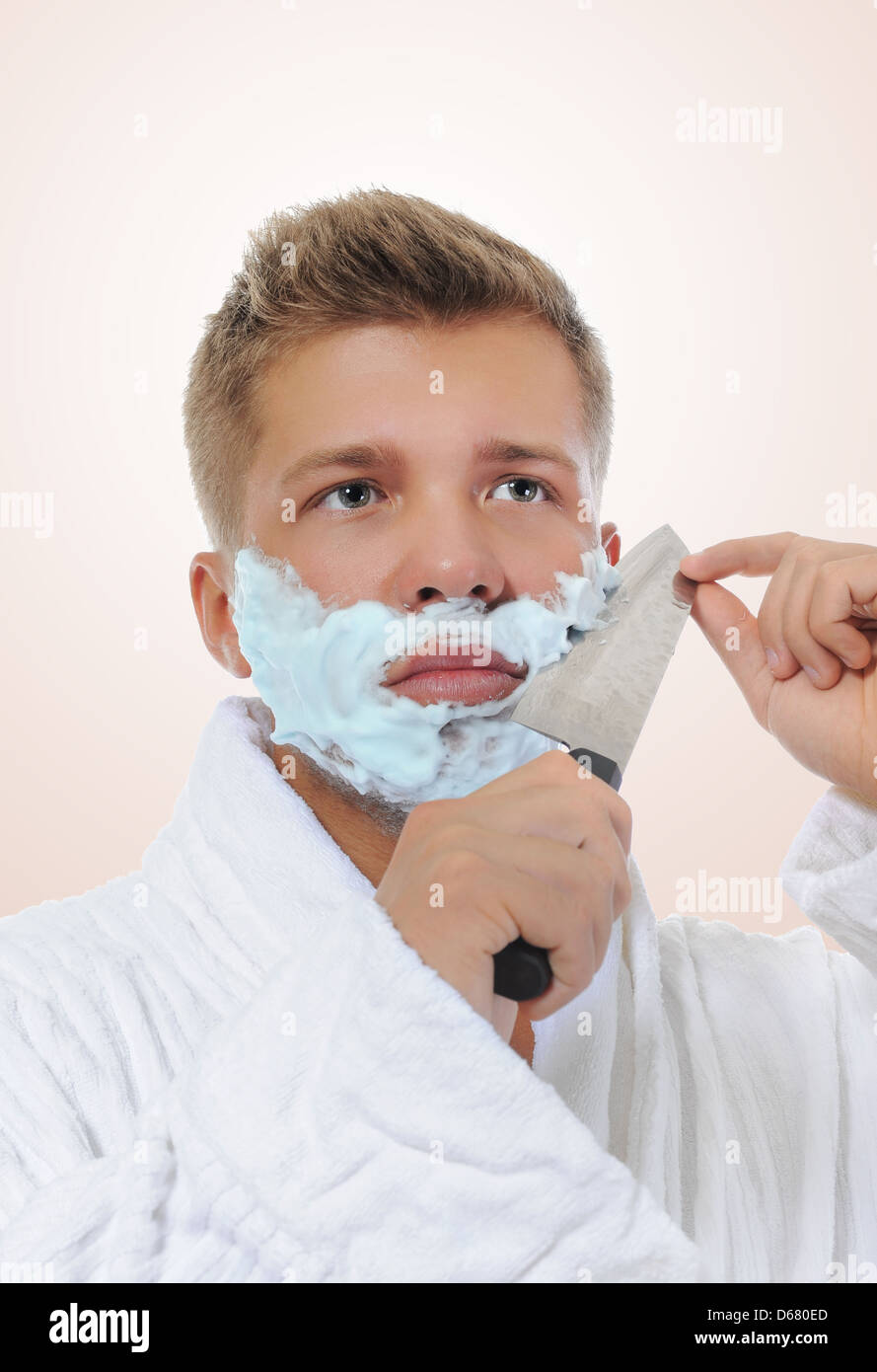 Young man shaving Stock Photo - Alamy