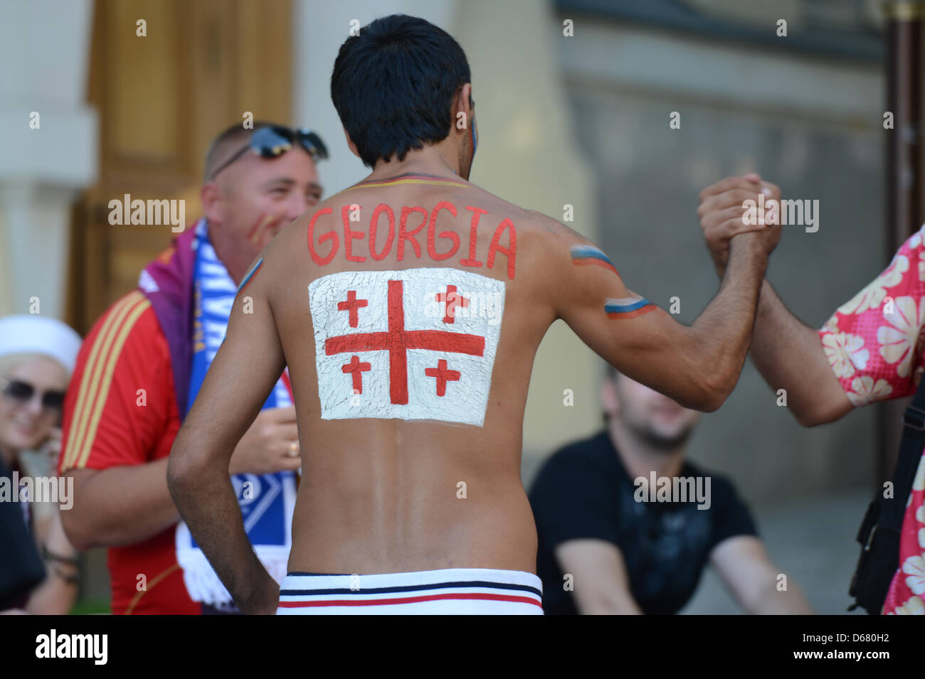 A Georgian fan shakes hands prior to the UEFA EURO 2012 final soccer ...