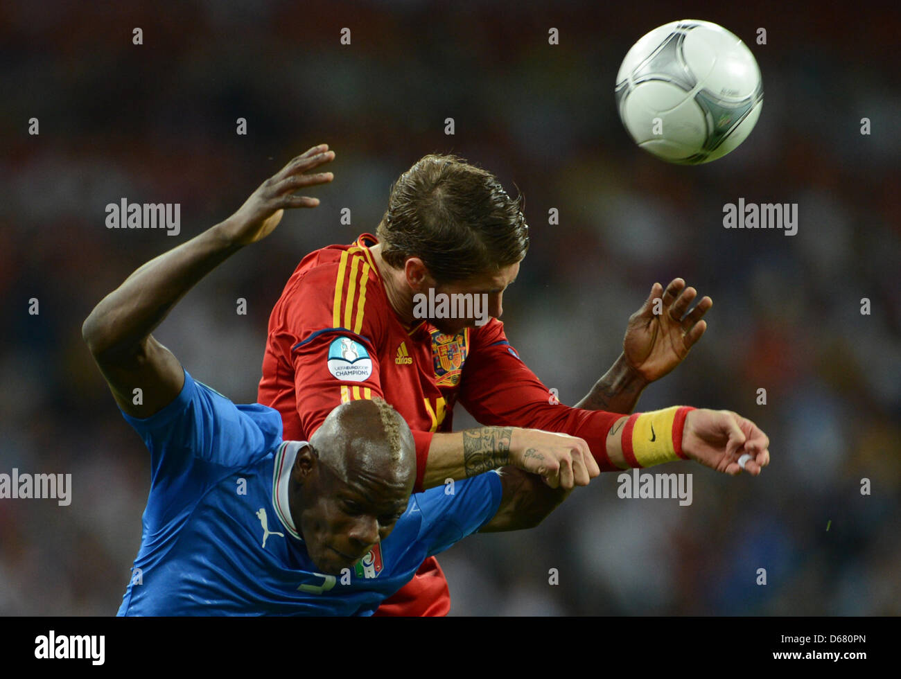 Spain's Sergio Ramos (top) and Italy's Mario Balotelli vie for the ball ...