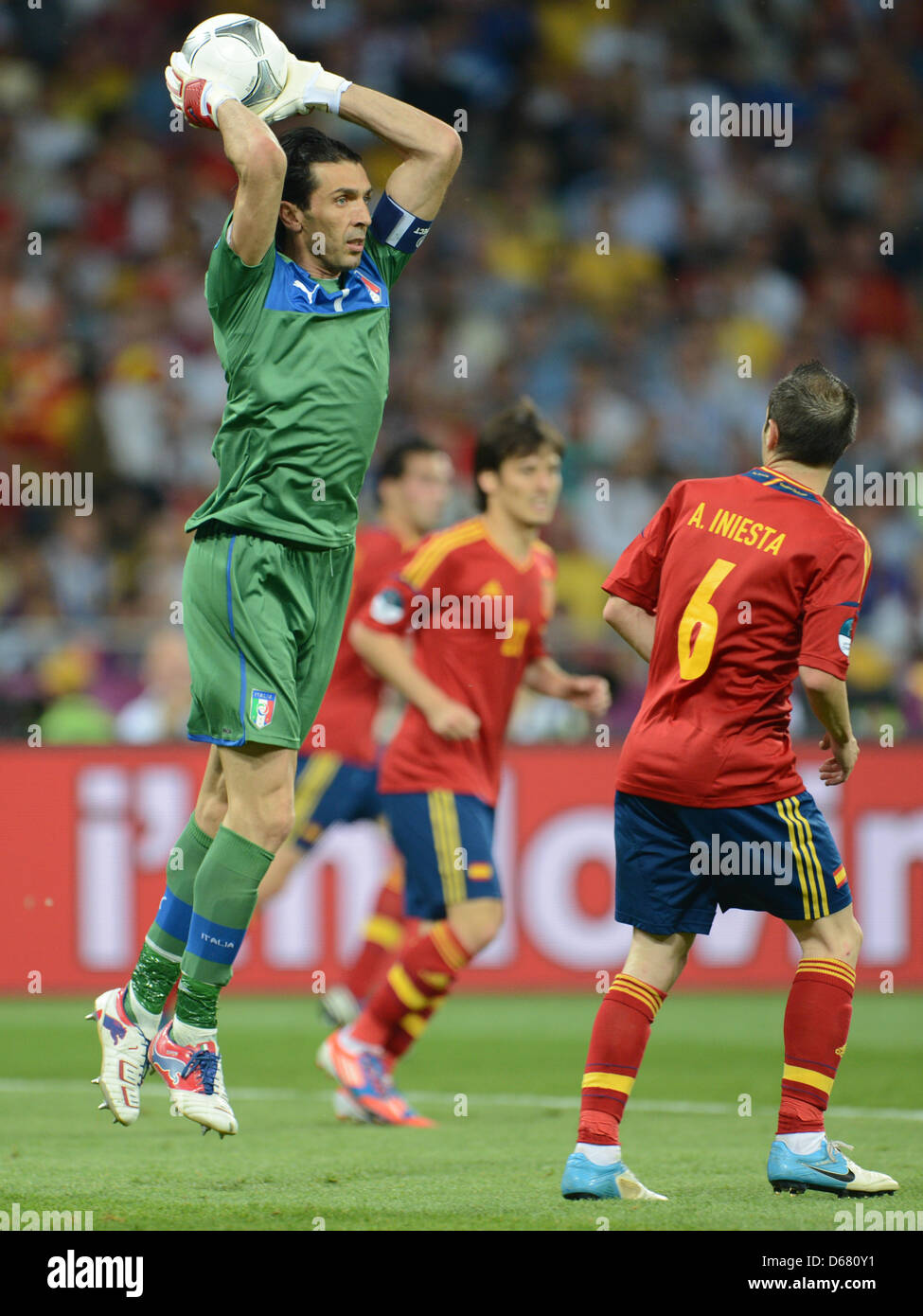 Spain's Andres Iniesta (R) and Italy's goal keeper Gianluigi Buffon vie ...
