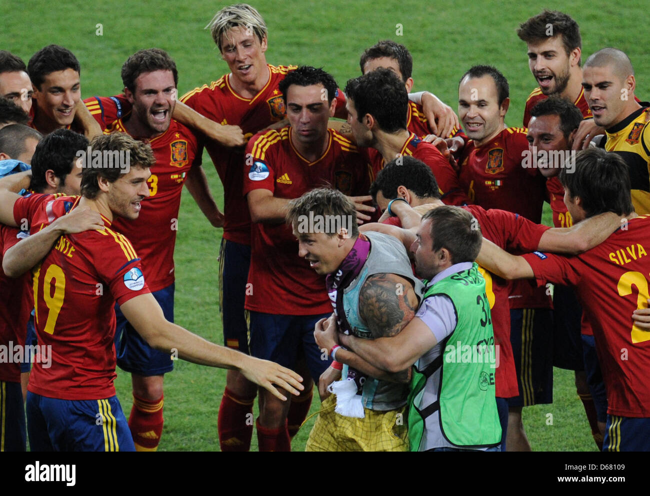 A streaker on the pitch next to the celebrating spanish team after the ...