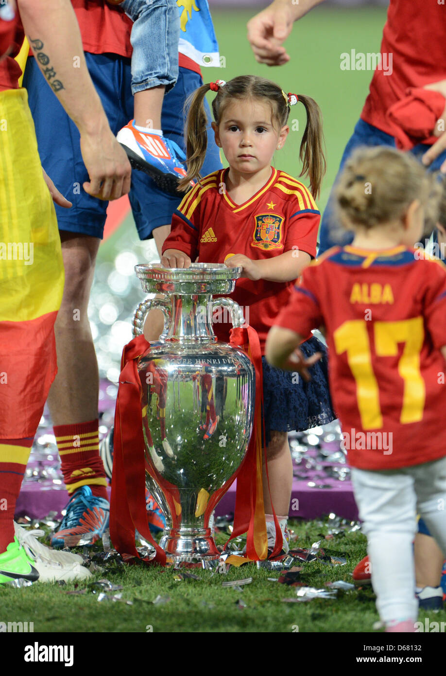 Nora, daughter of Spain's Fernando Torres plays with the trophy after ...
