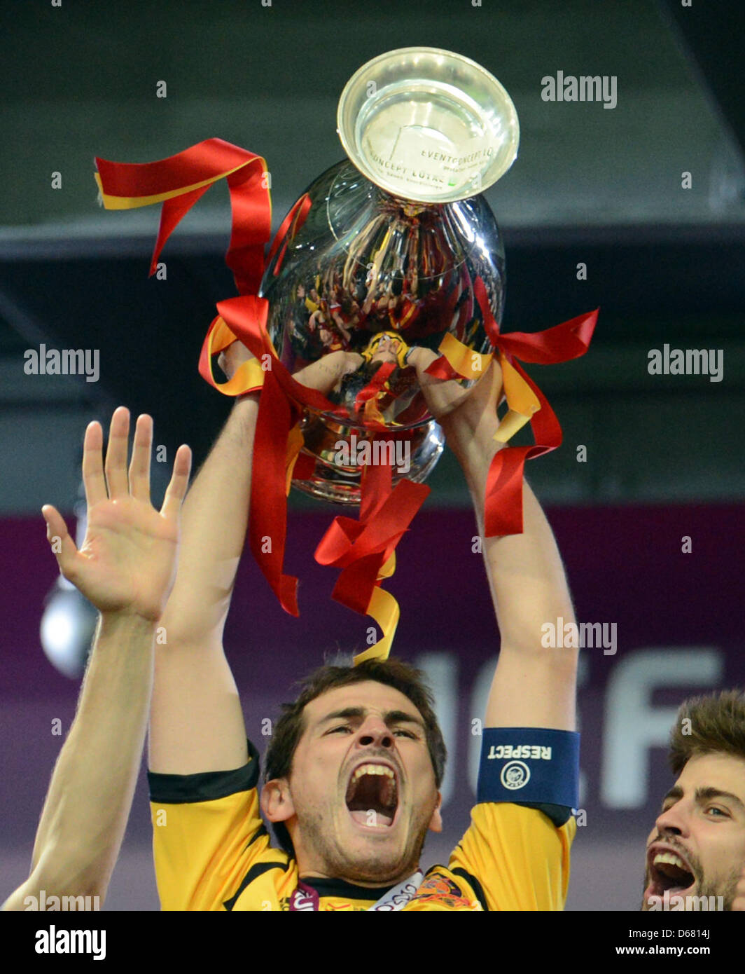 Spain's goalkeeper Iker Casillas lifts the trophy as his teammates ...