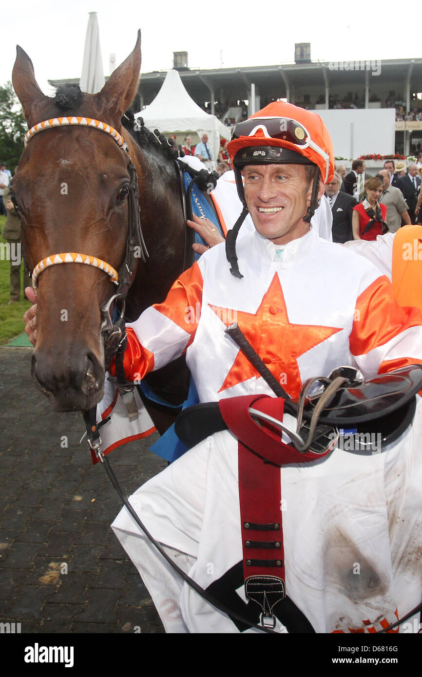 Jockey Terence Hellier cheers next to his horse 'Pastorius' after ...