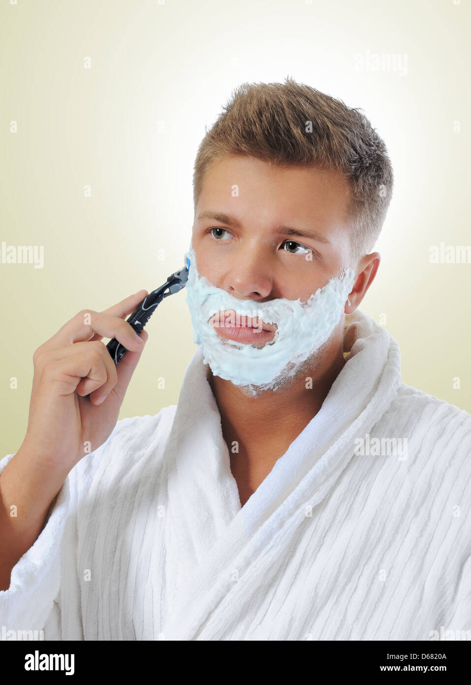 Young man shaving Stock Photo - Alamy