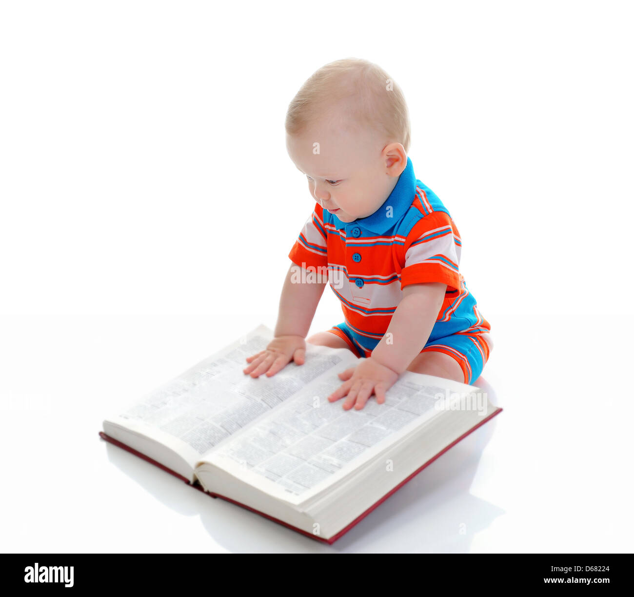Little boy reads a big book Stock Photo - Alamy