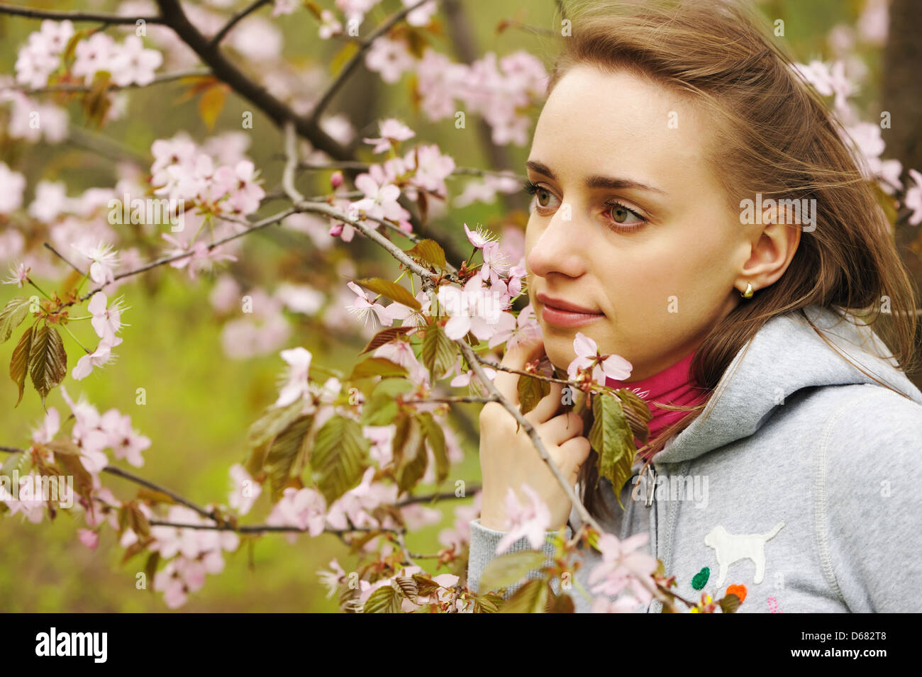 Woman in front of sakura blossoms Stock Photo - Alamy