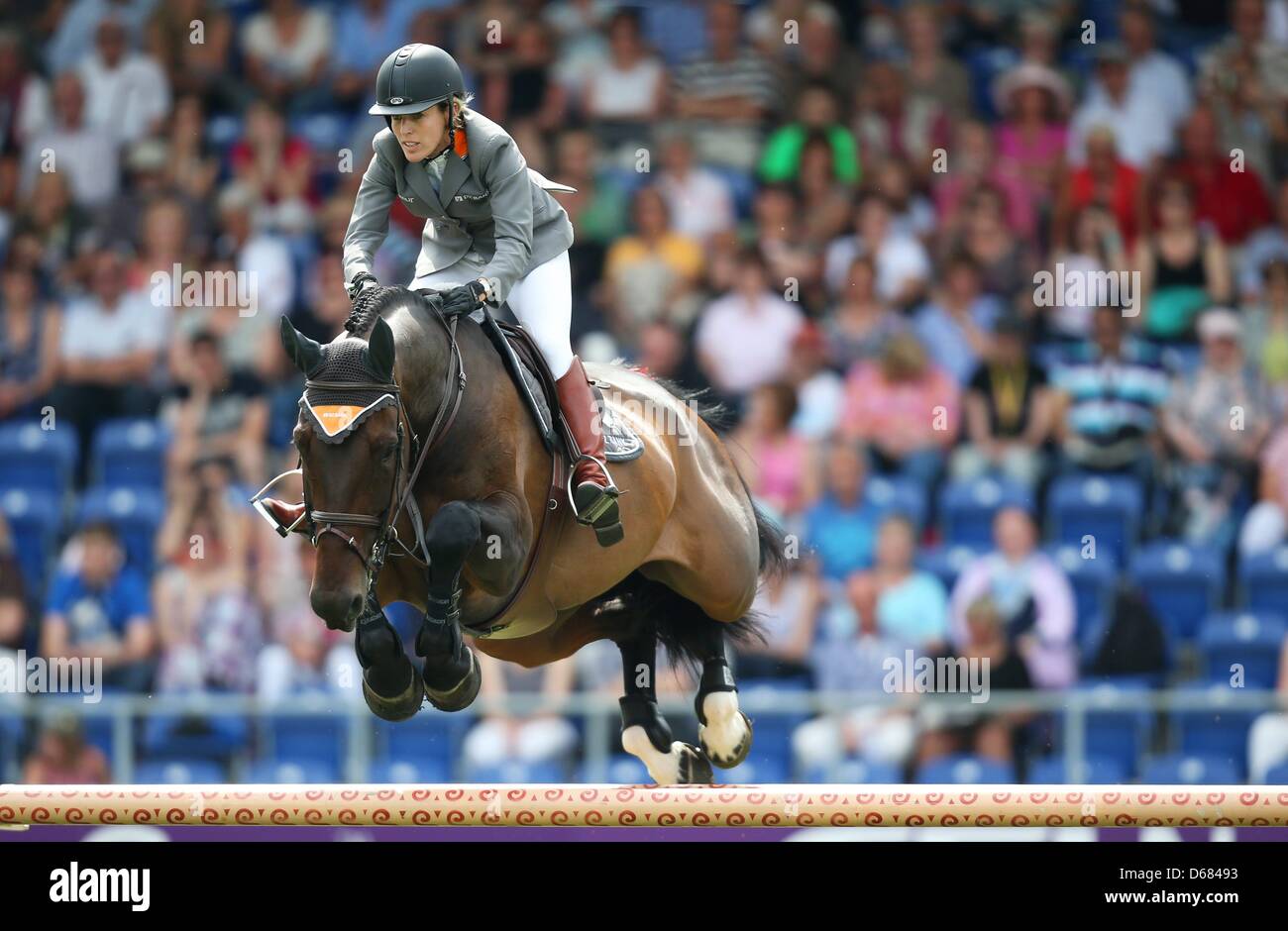 German show jumper Meredith Michaels-Beerbaum jumps over a hurdle on ...