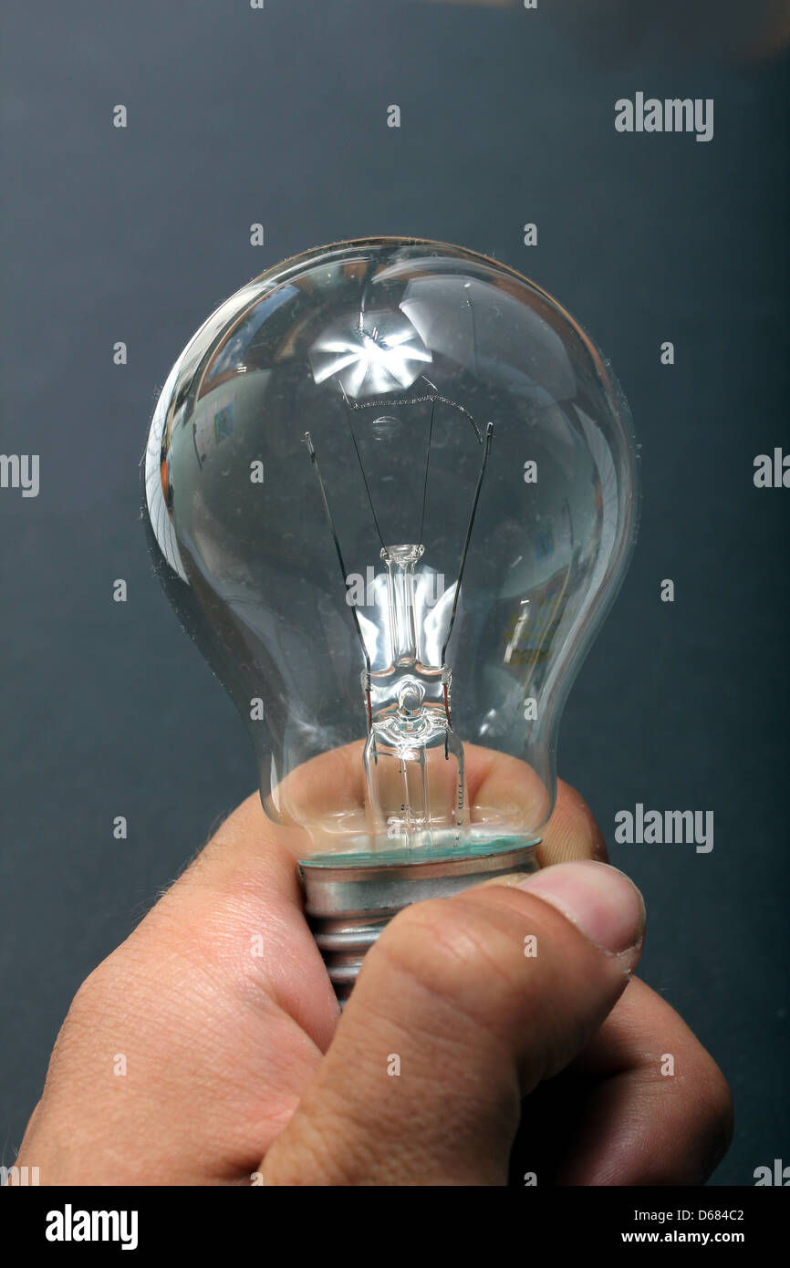 plain light bulb in human hand Stock Photo - Alamy