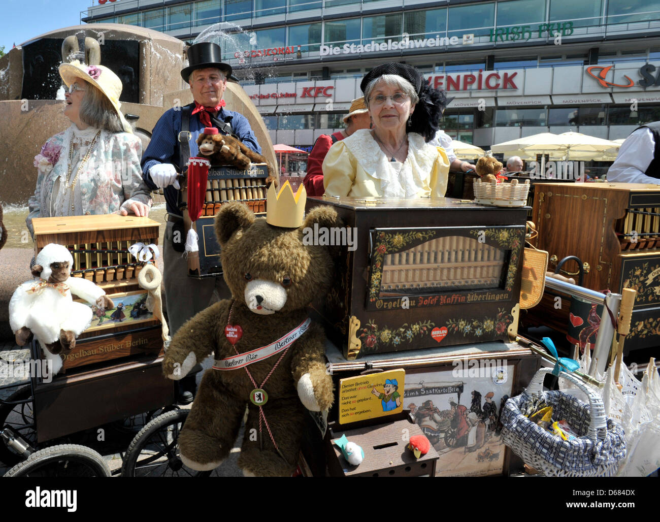 Barrel organ players pose with their barrel organs during a photo ...