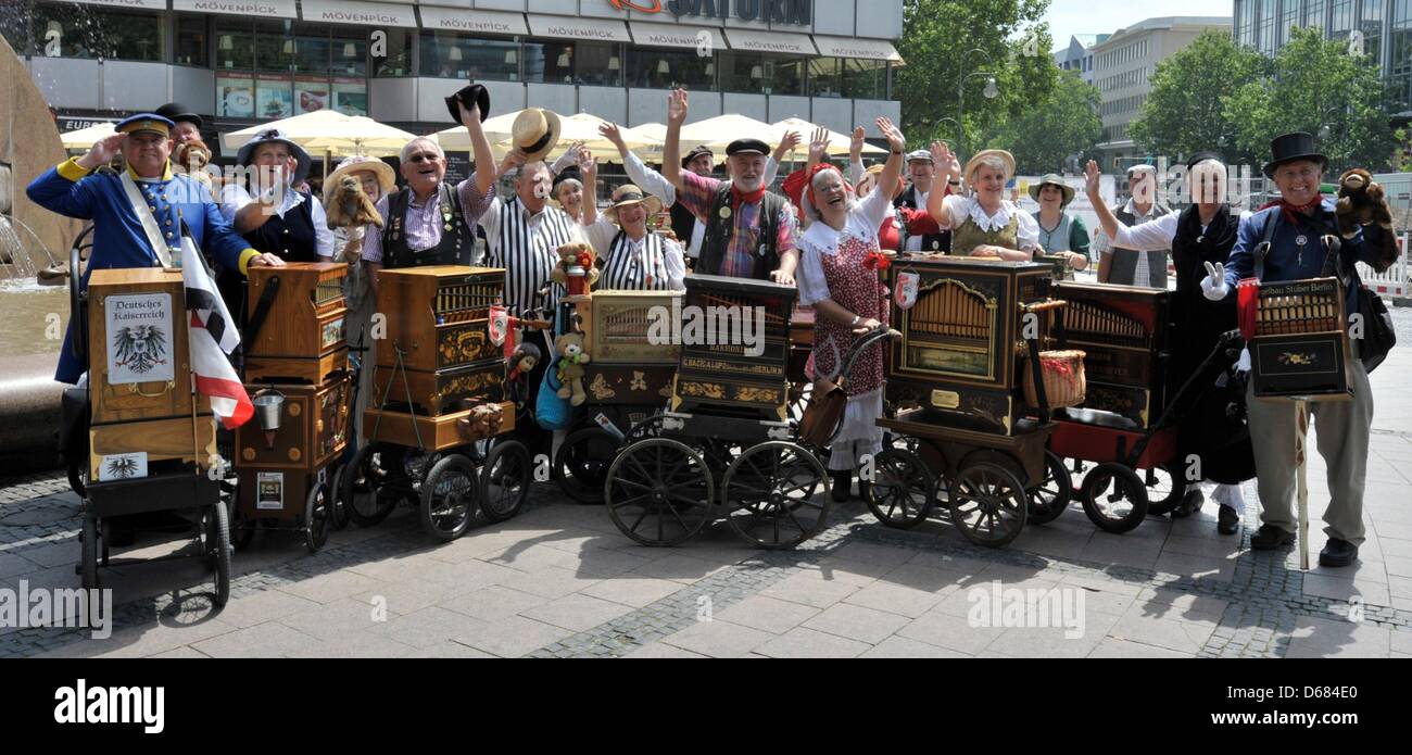 Barrel organ players pose with their barrel organs during a photo ...