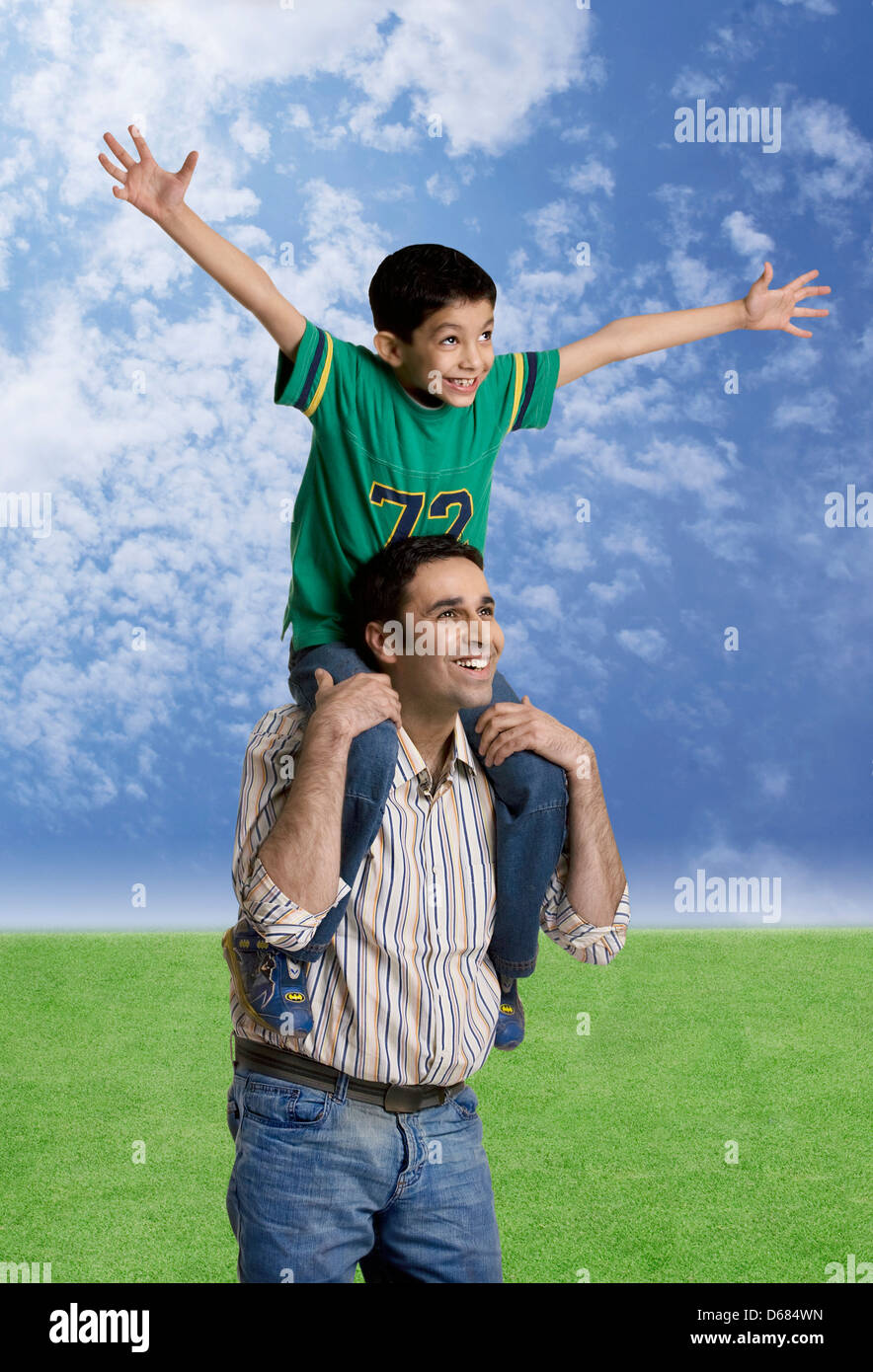 Son sitting on his fathers shoulders Stock Photo - Alamy