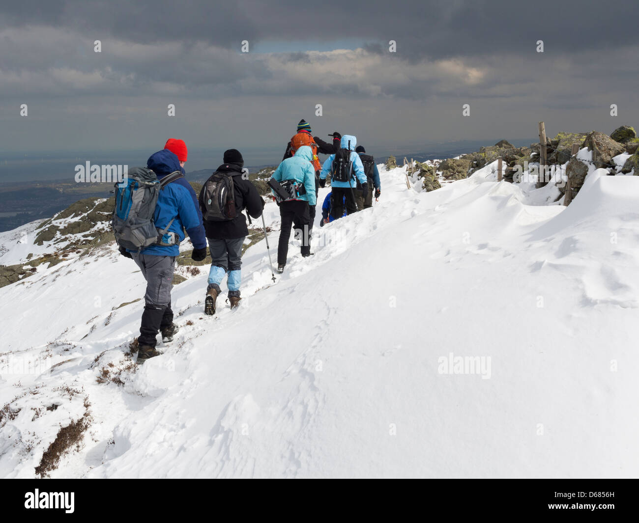 Group of Ramblers walking on ridge of Tal-y-Fan mountain in deep snow ...