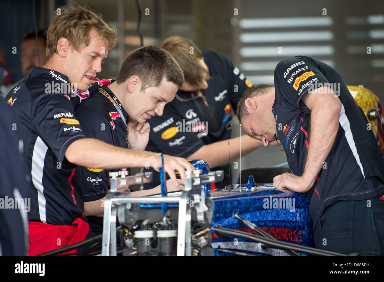 German Formula One driver Sebastian Vettel (L) of Red Bull and his ...
