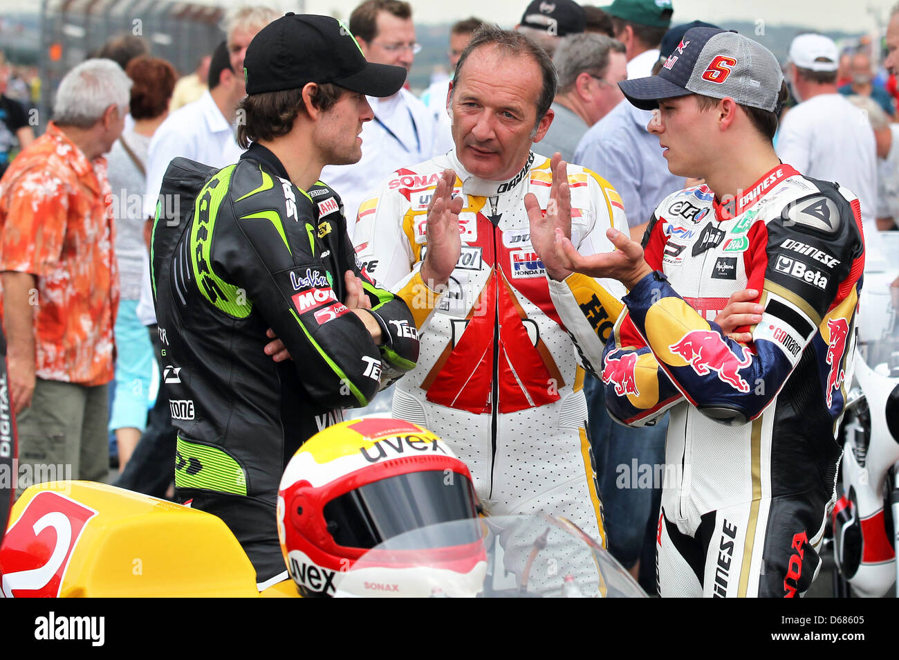 Motorcycle racers Helmut (C) and Stefan Bradl (R) and Cal Crutchlow (L ...