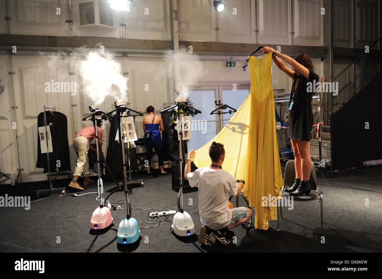 Volunteers prepare a yellow outfit of the Guido Maria Kretschmer ...