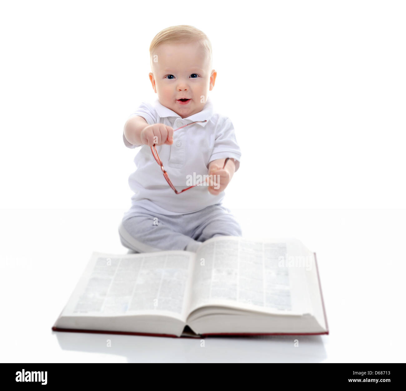 Little boy reads a big book Stock Photo - Alamy