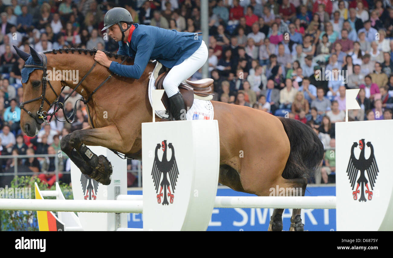 French show jumper Olivier Guillon and horse Lord De Theize jump over ...