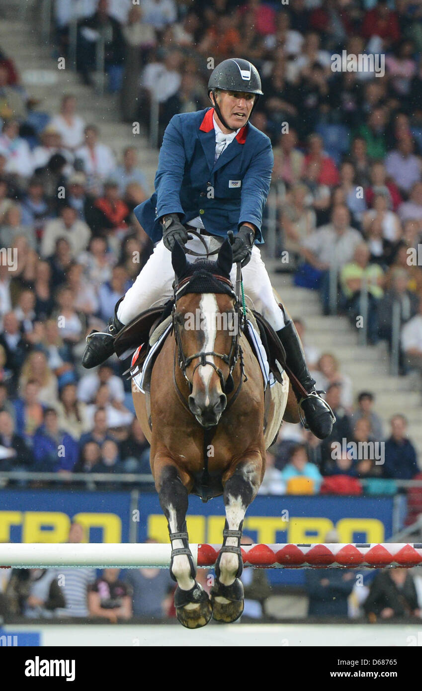 French show jumper Roger Yves Bost and horse Nippon jump over an ...