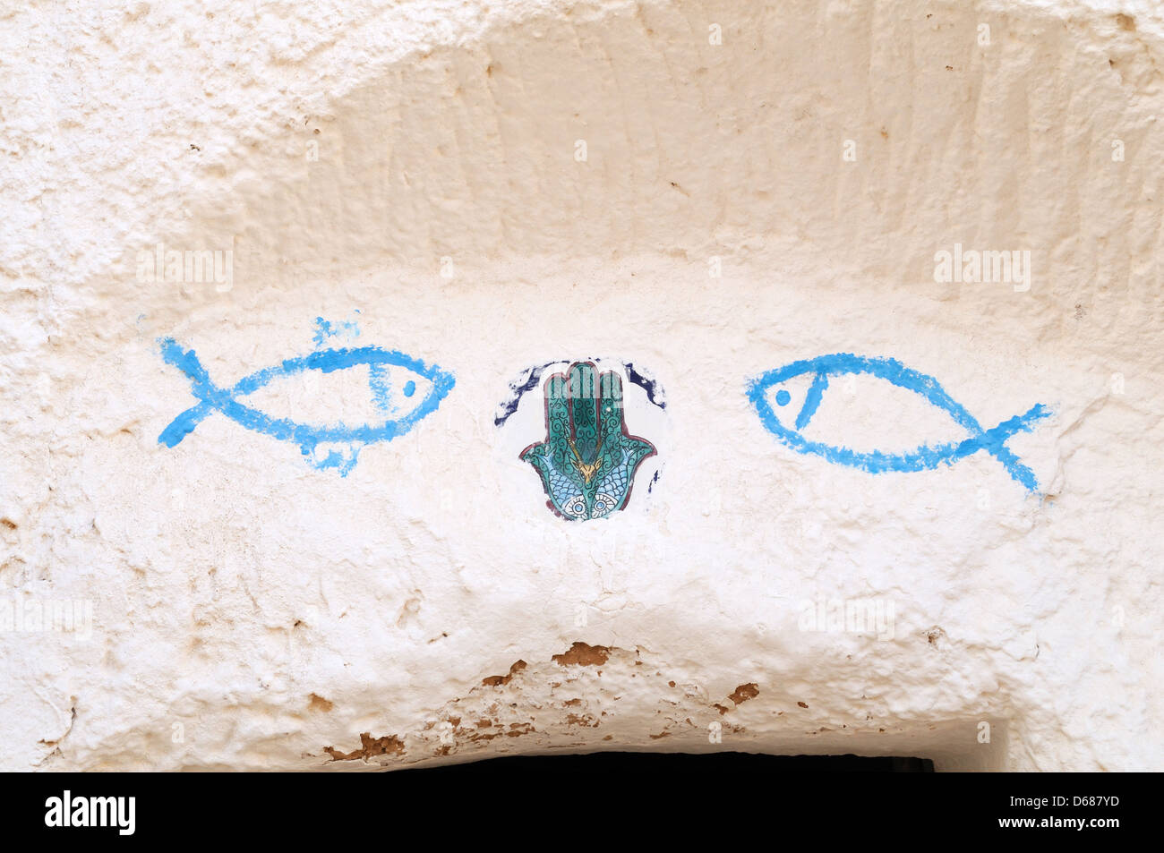 Hand of Fatima and fish on the wall of a Troglodyte cave house for ...