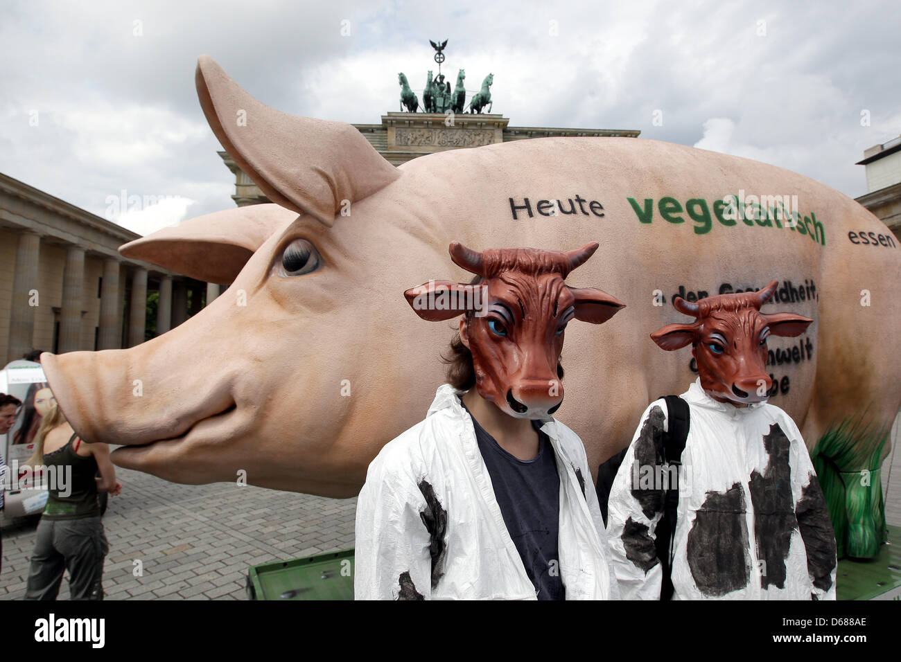 Vegetarian demonstrators dressed as cows protest against the ...