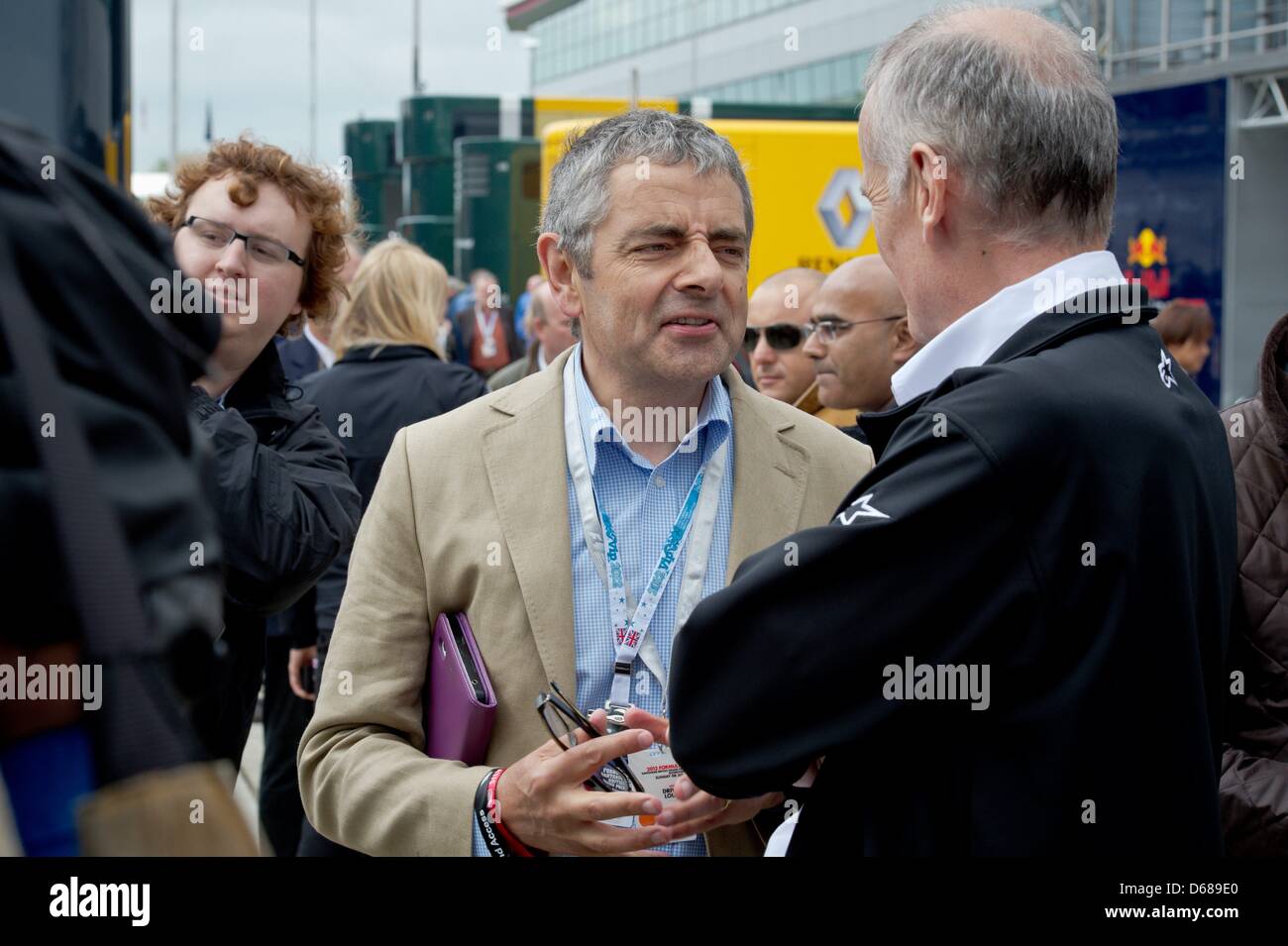 British comedian Rowan Atkinson chats with an unidentified man in the ...