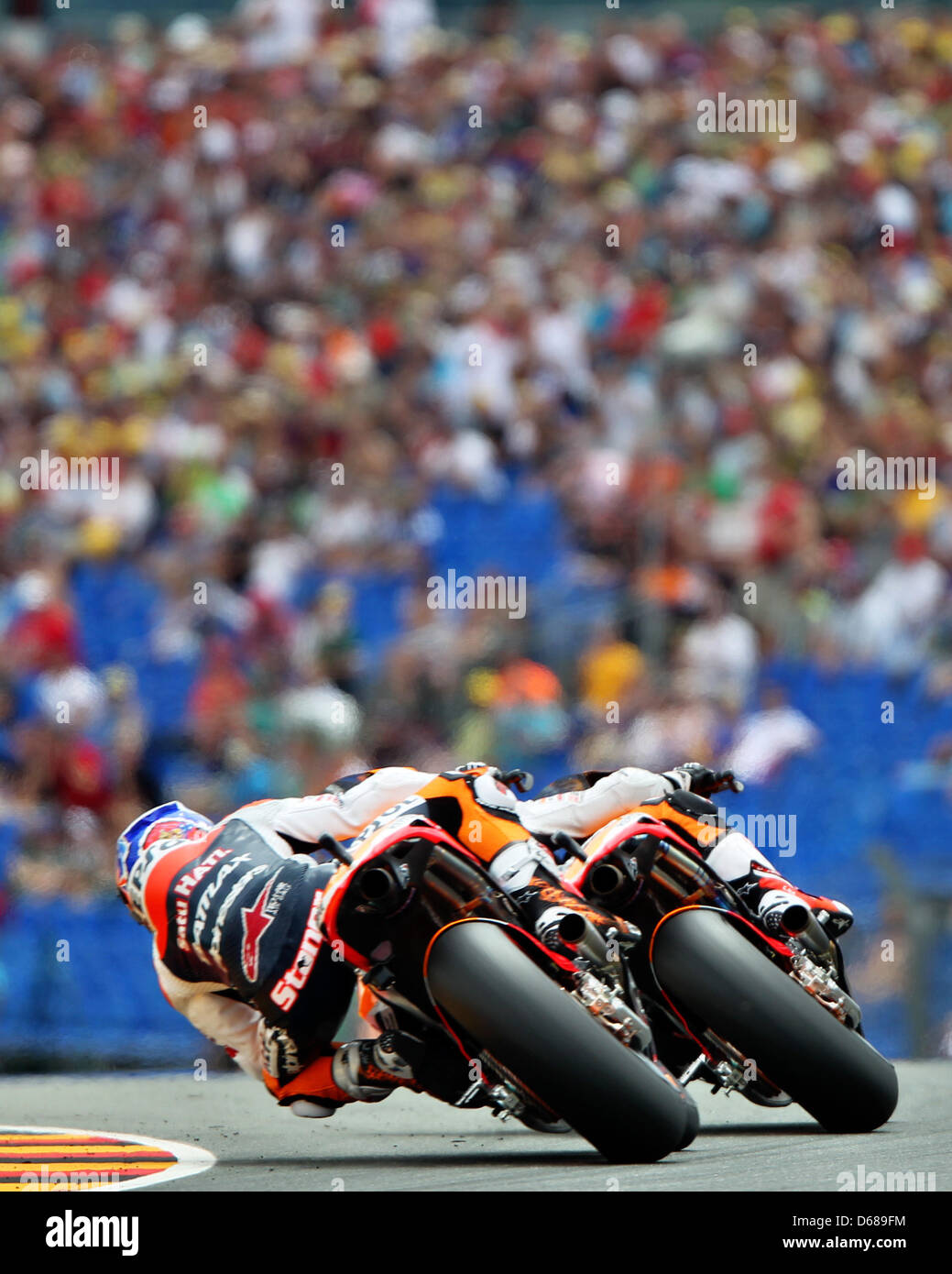 Spanish rider Daniel Pedrosa of Team Repsol Honda (R) races in front of ...
