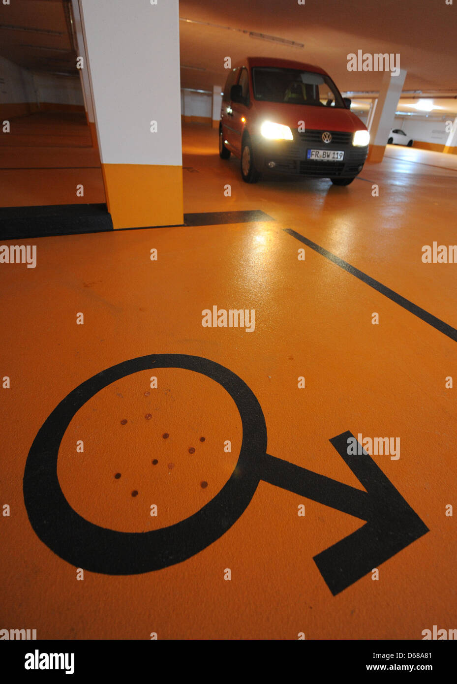 A car stands in front of a parking lot for men in a parking garage in ...
