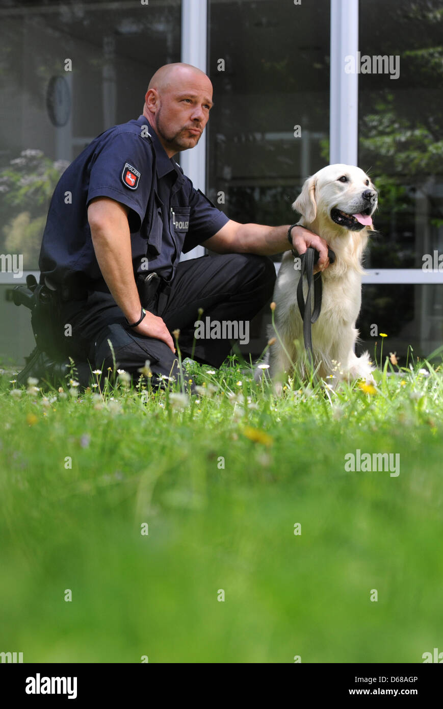 A police officer poses for the media with pyrotechnics tracking dog ...