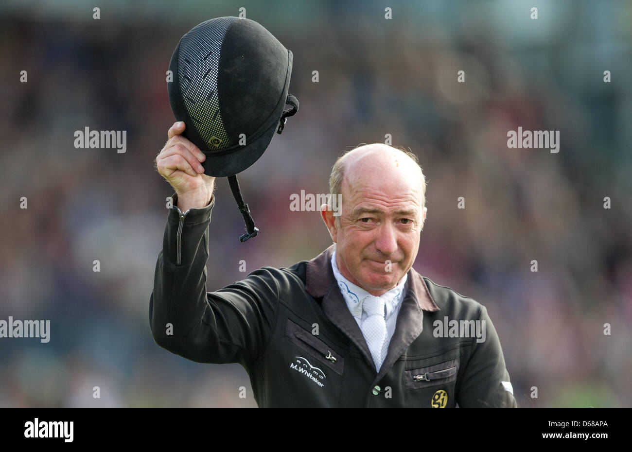 British show jumper Michael Whitaker celebrates his win atop his horse ...