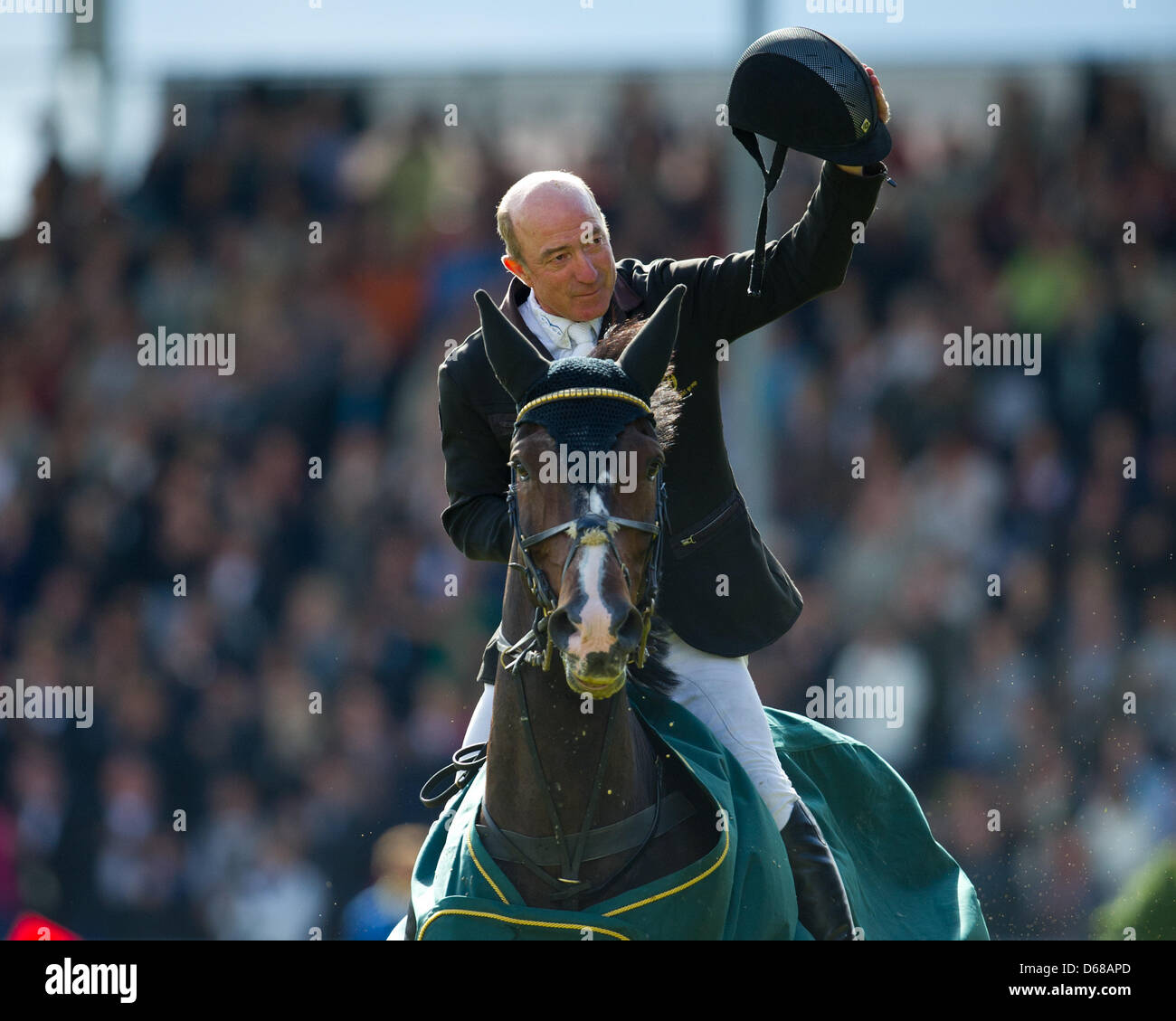 British show jumper Michael Whitaker celebrates his win atop his horse ...