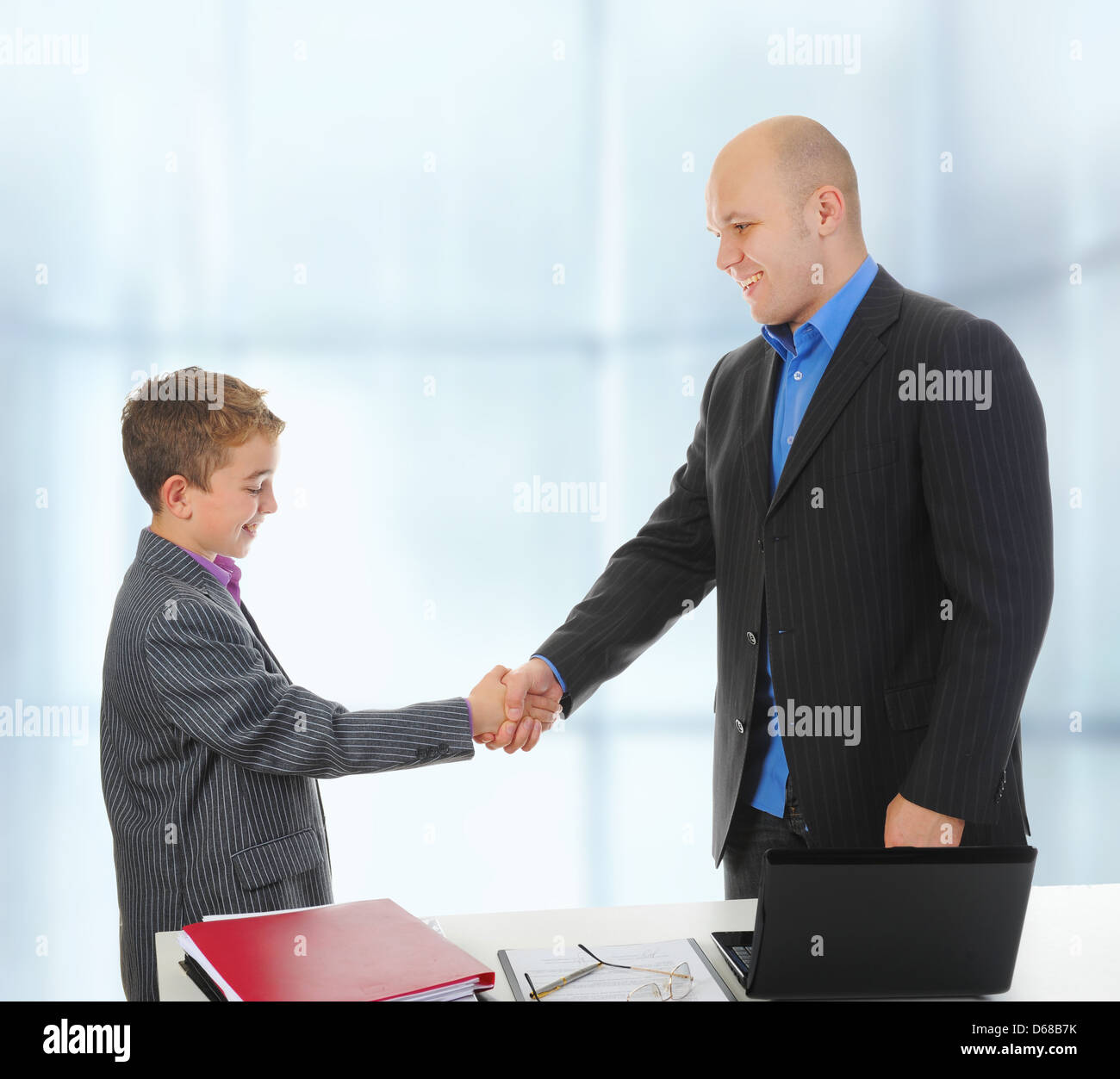 Handshake man and boy Stock Photo - Alamy