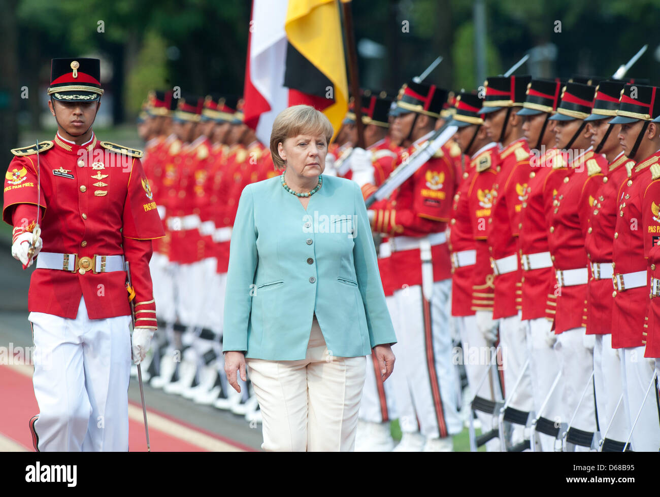 German Chancellor Angela Merkel is received with military honors at the ...