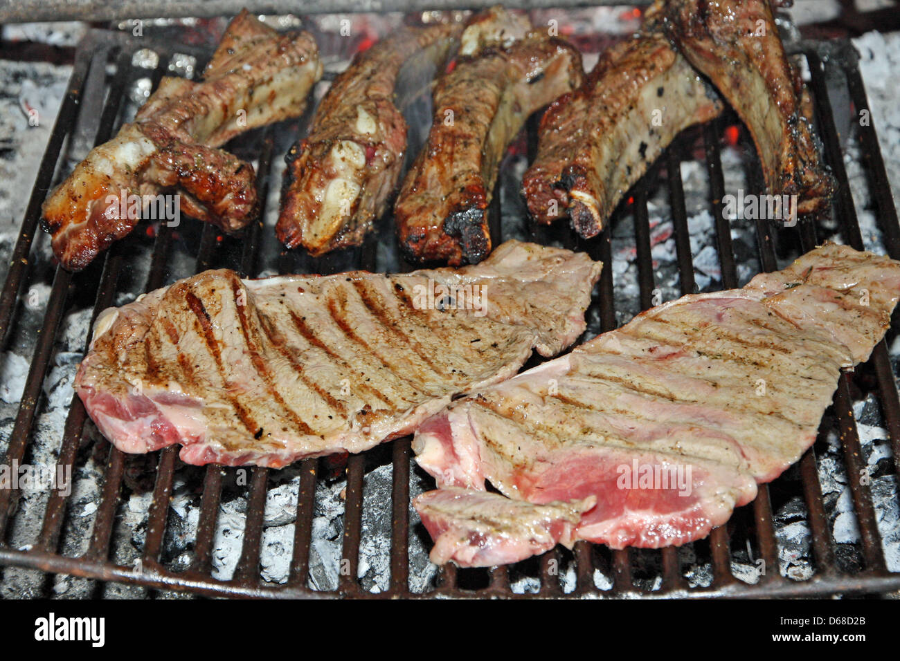 beef steaks and chops cooked barbecued pork on the barbecue grill Stock ...