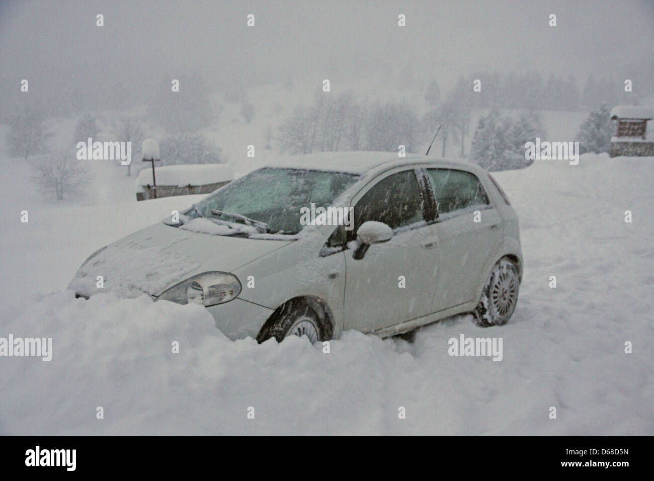car covered with snow during a winter snowstorm Stock Photo - Alamy