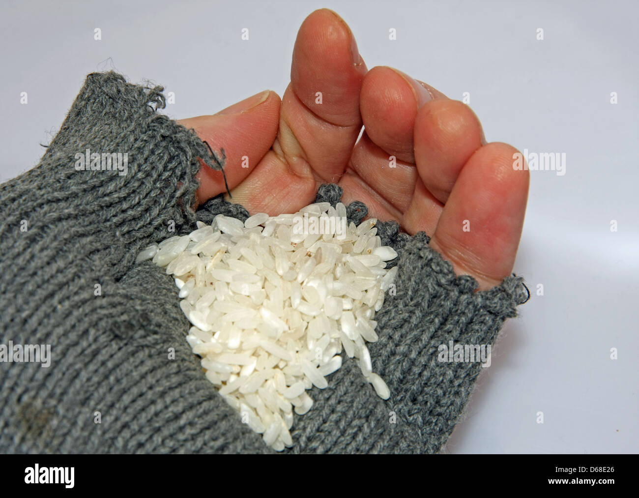 hand of poor man holding a handful of rice Stock Photo - Alamy