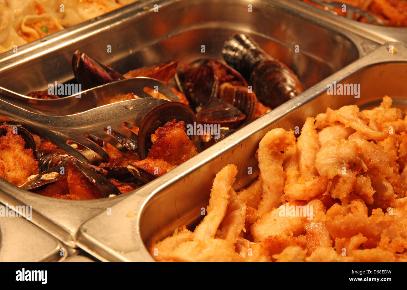 stuffed mussels and fried chicken at the self service restaurant Stock ...