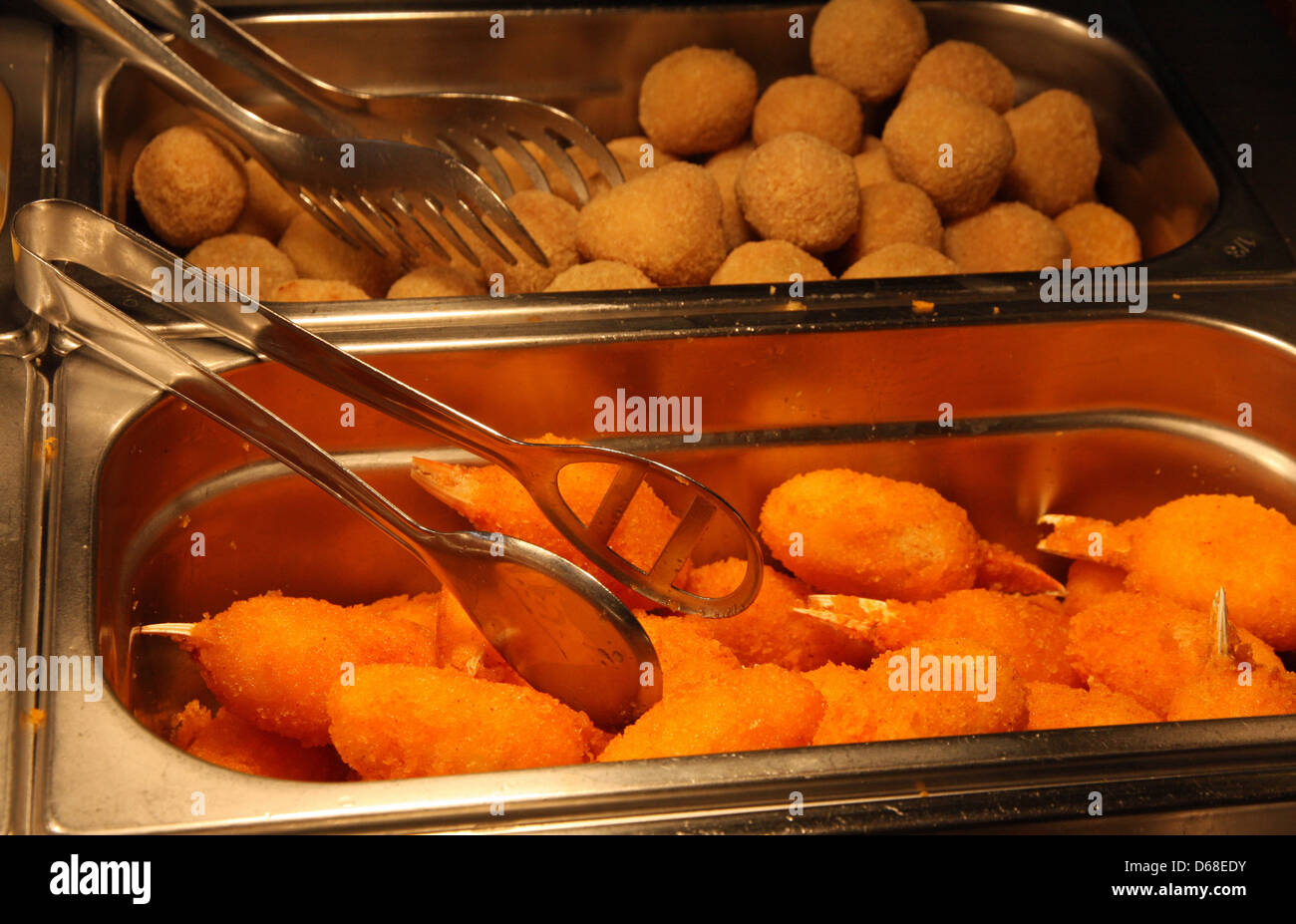steel tray filled with Fried crab claws and stuffed olives in a ...