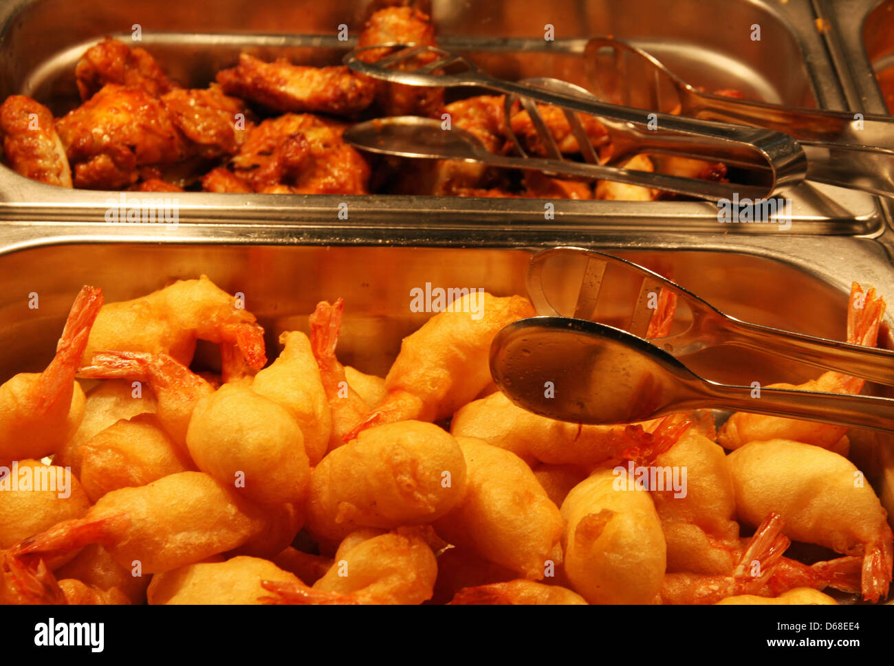 steel tray filled with fried meat and fish within the self service ...