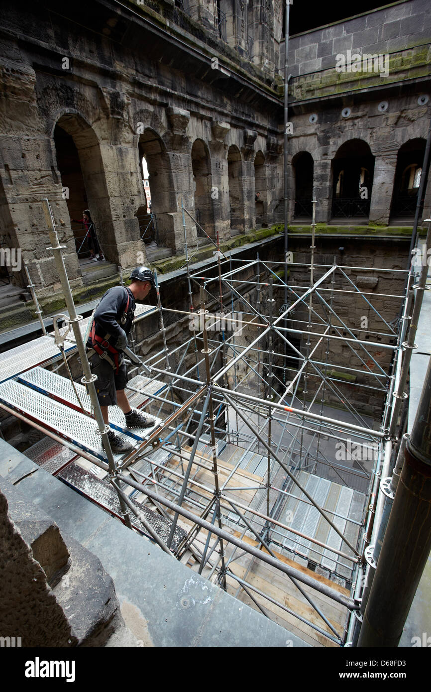 Construction workers erect a scaffolding within an arch of the Porta ...