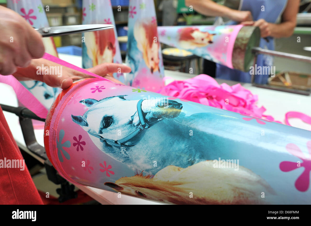 An employee of Nestler Feinkartonagen GmbH finishes a 'sugar cone' in ...