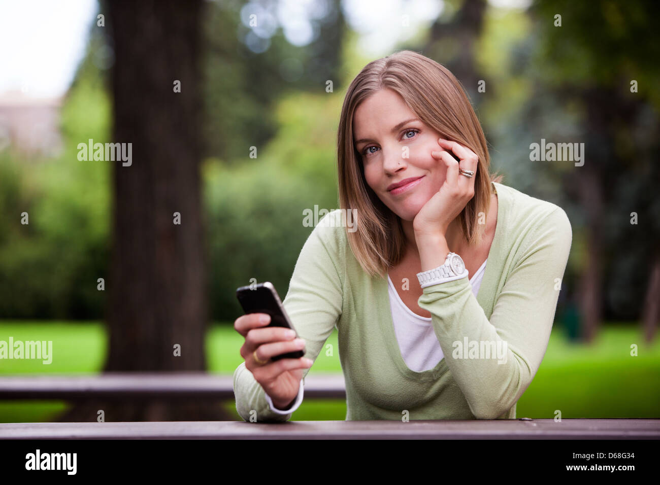 Woman holding Cell Phone Stock Photo - Alamy