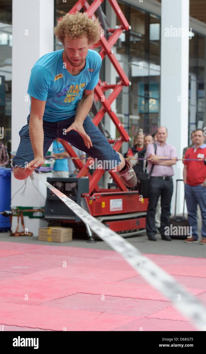 American slackliner Andy Lewis performs tricks on a slackline from ...
