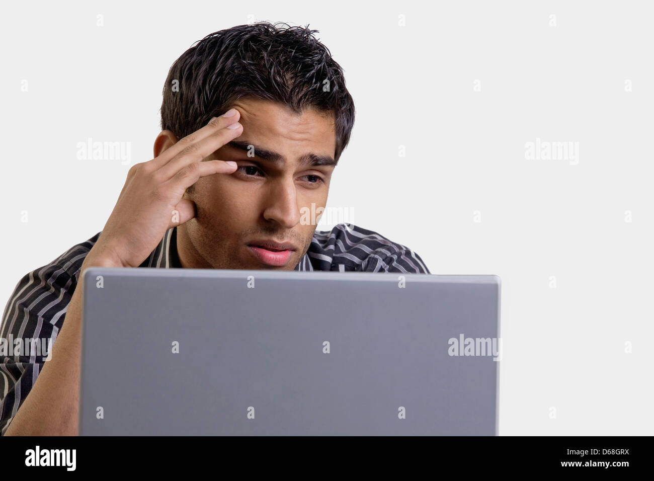 Man tensed while working on laptop Stock Photo - Alamy