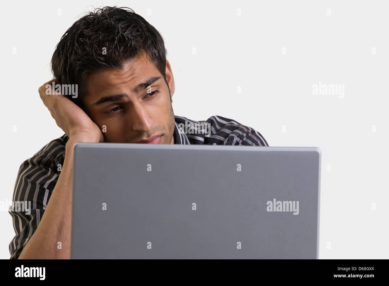 Man tensed while working on laptop Stock Photo - Alamy